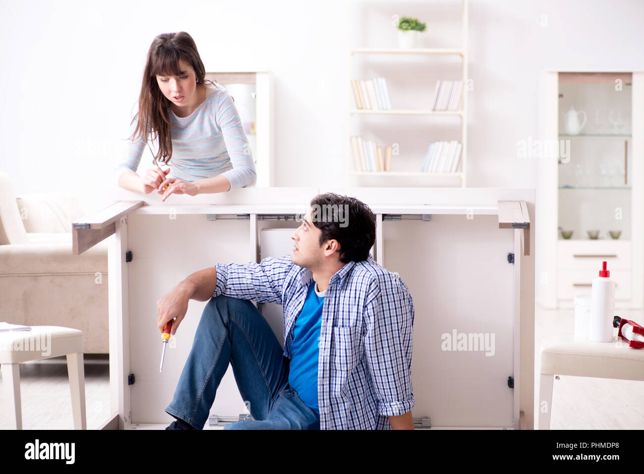 Husband repairing broken table at home Stock Photo - Alamy