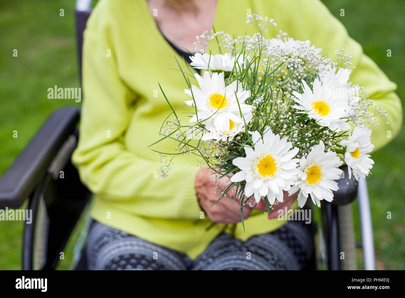 Elderly paralyzed woman receiving a flower bouquet - nursing home ...