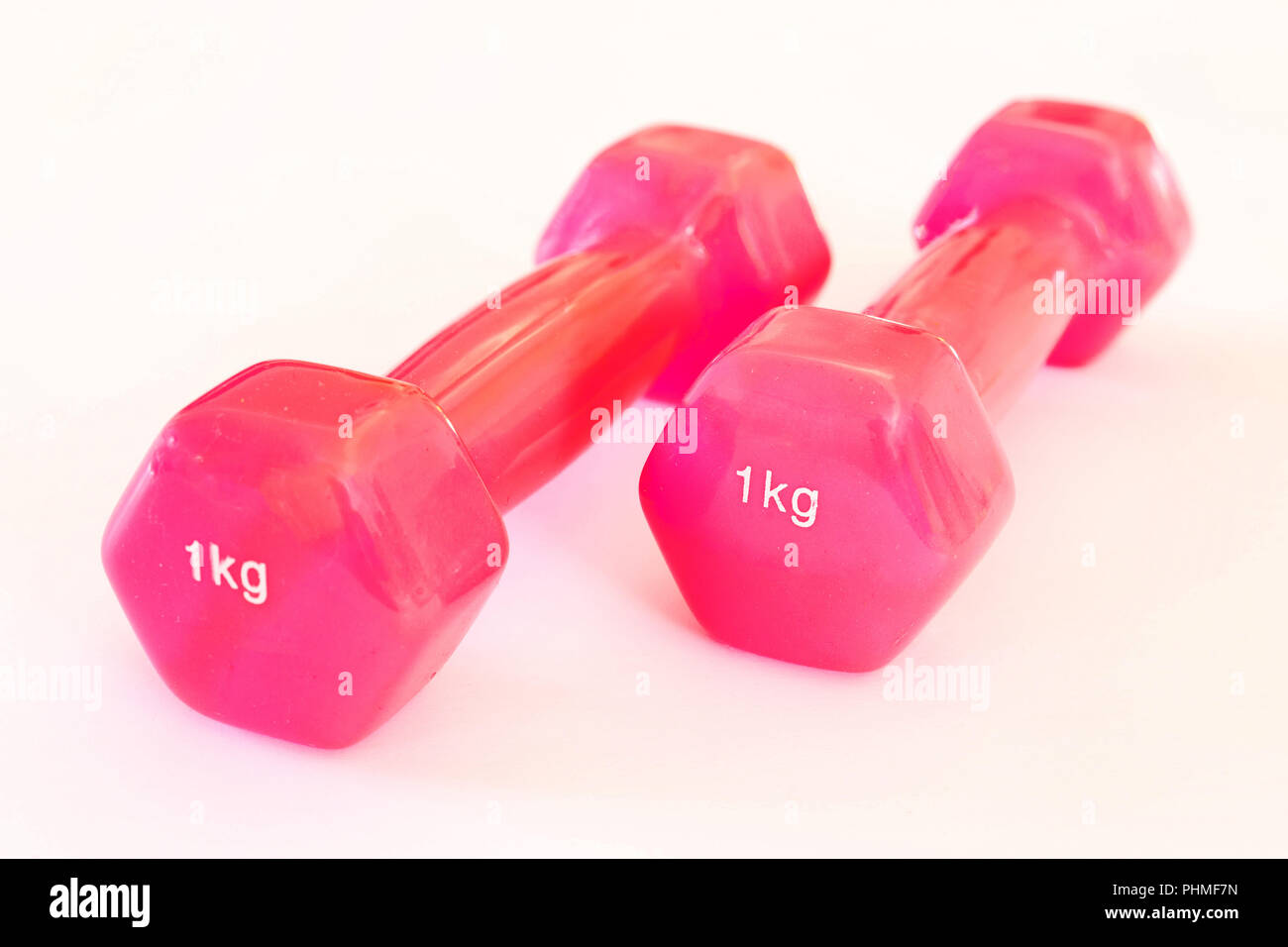 1 KG pink dumbbells on white background Stock Photo - Alamy