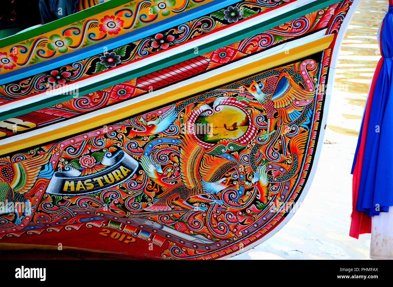 Beautiful painted Asian dragon and floral art on hull of Thai fishing ...