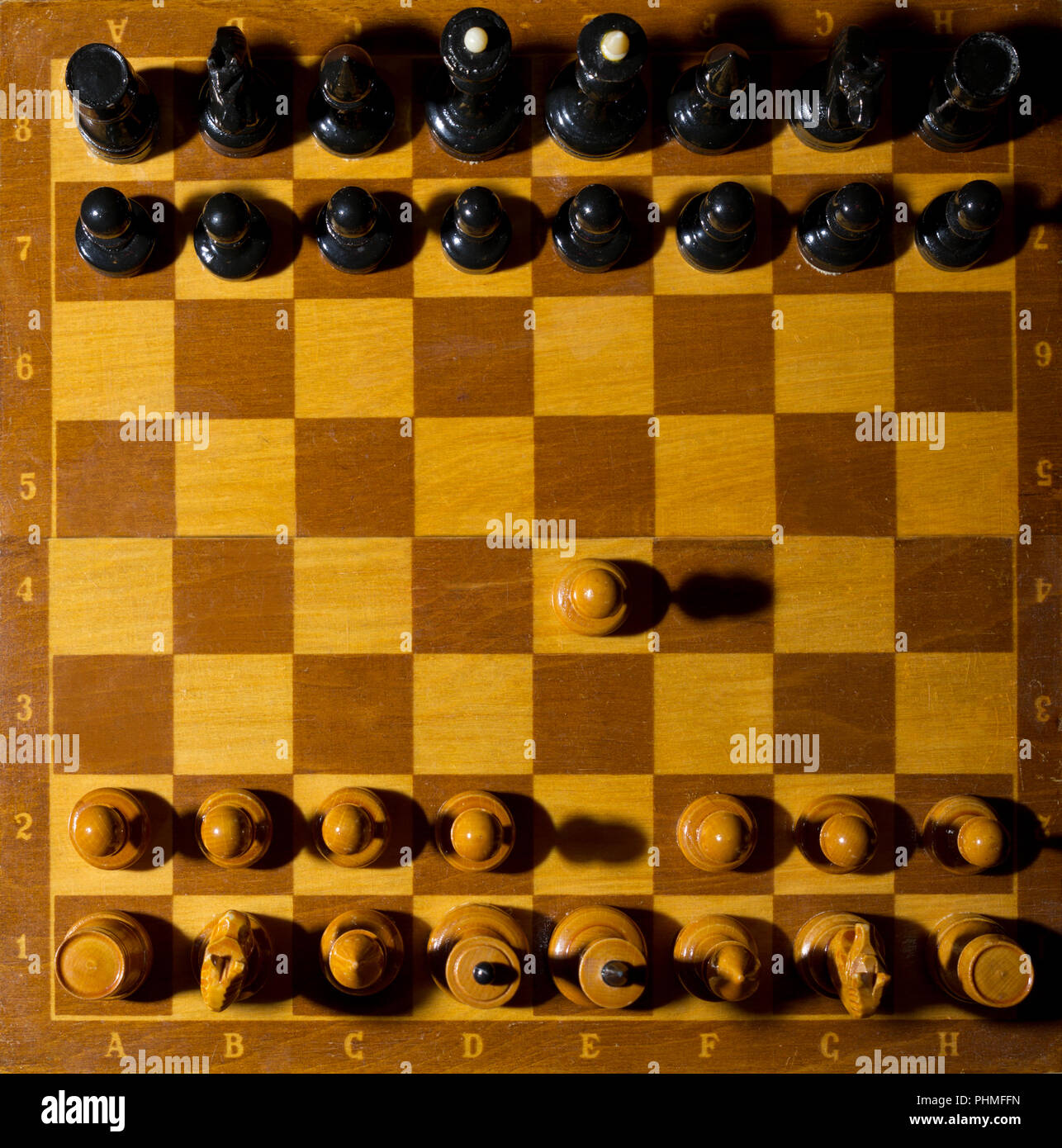 Chessboard with figures on dark background Stock Photo - Alamy