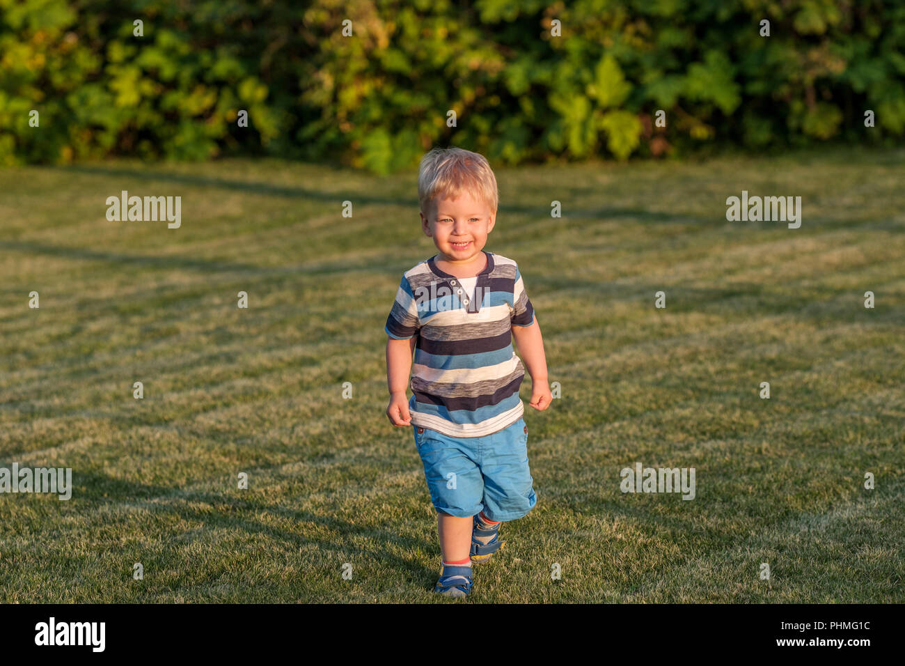 One year old baby boy running on meadow Stock Photo - Alamy