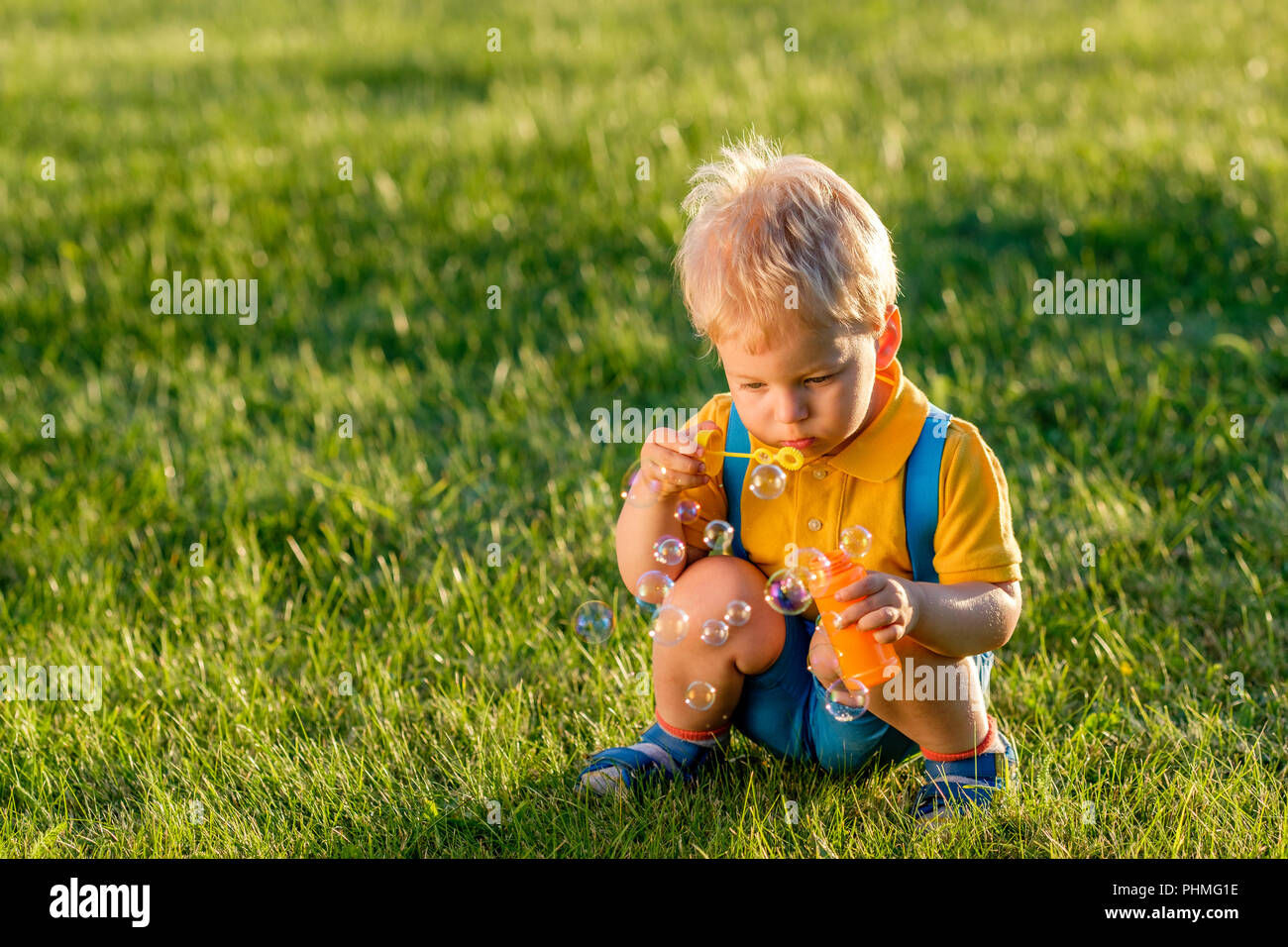 One year old baby boy blowing soap bubbles Stock Photo - Alamy