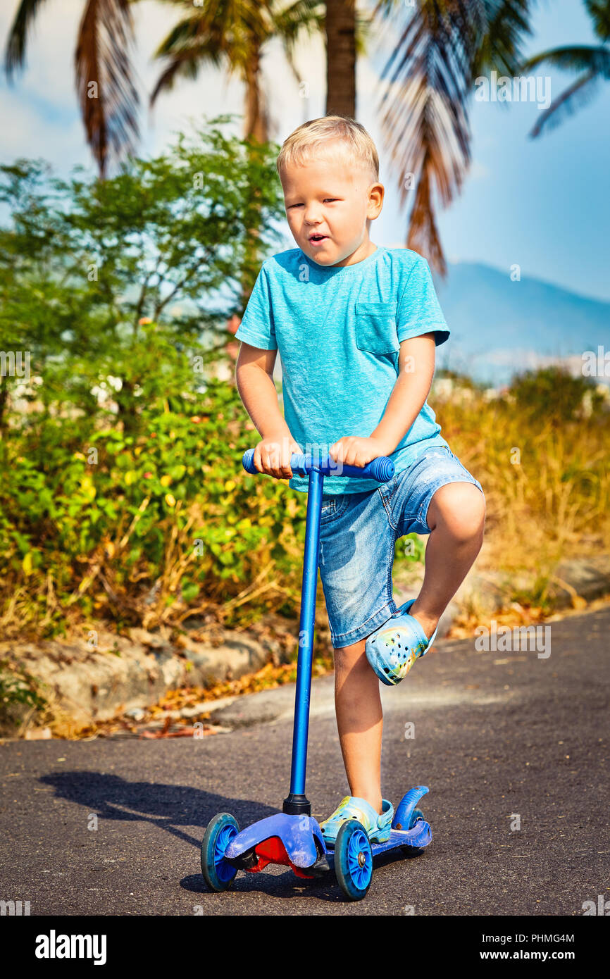 Child riding scooter Stock Photo - Alamy