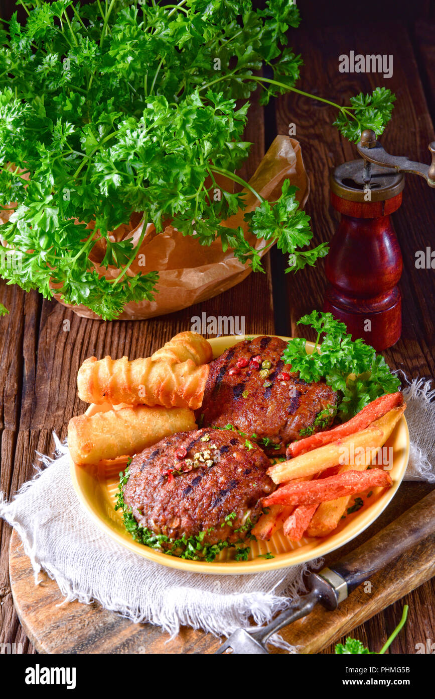 grilled bullets with croquettes and vegetables Stock Photo - Alamy
