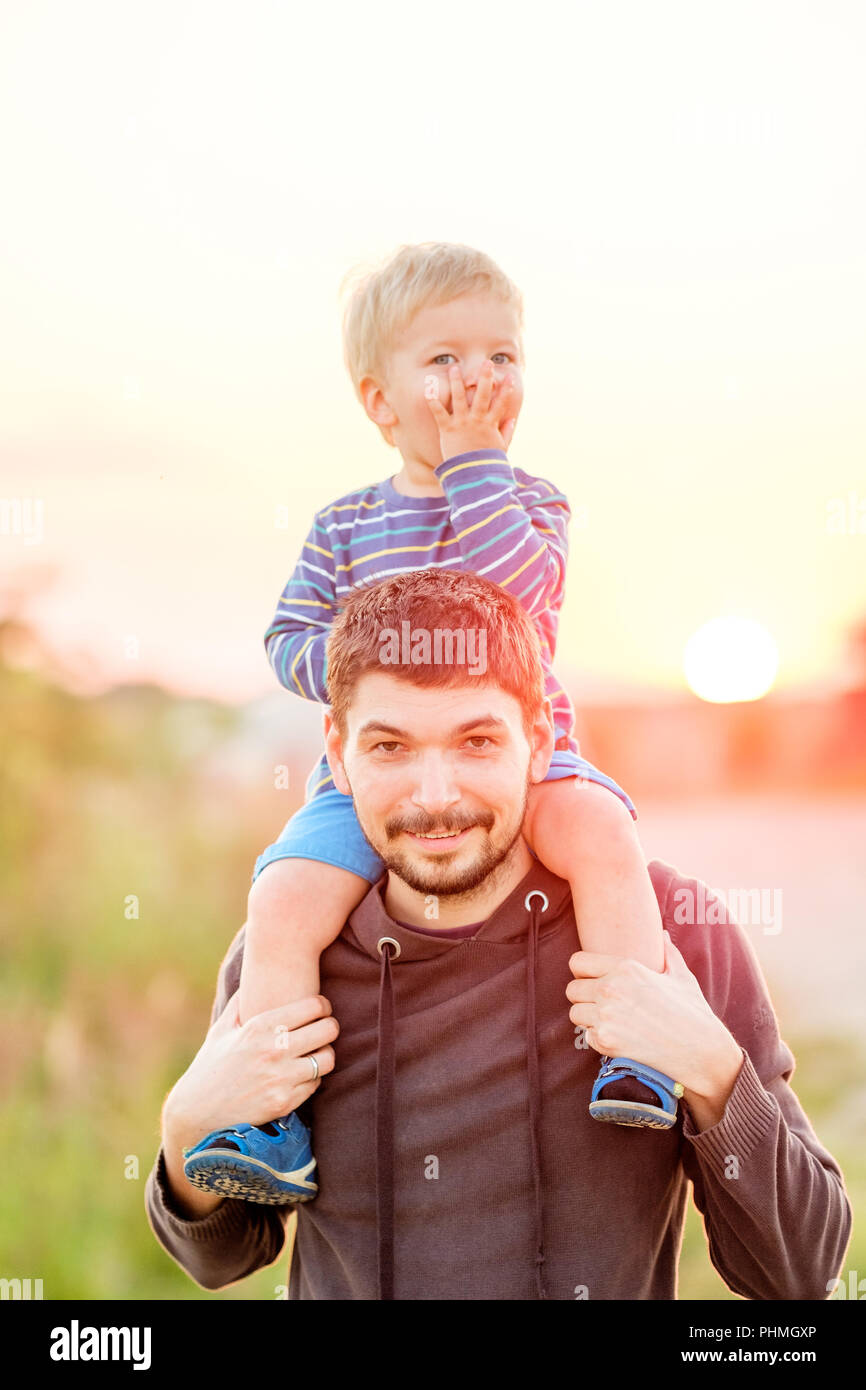 Father and son outdoor portrait in sunset sunlight Stock Photo - Alamy