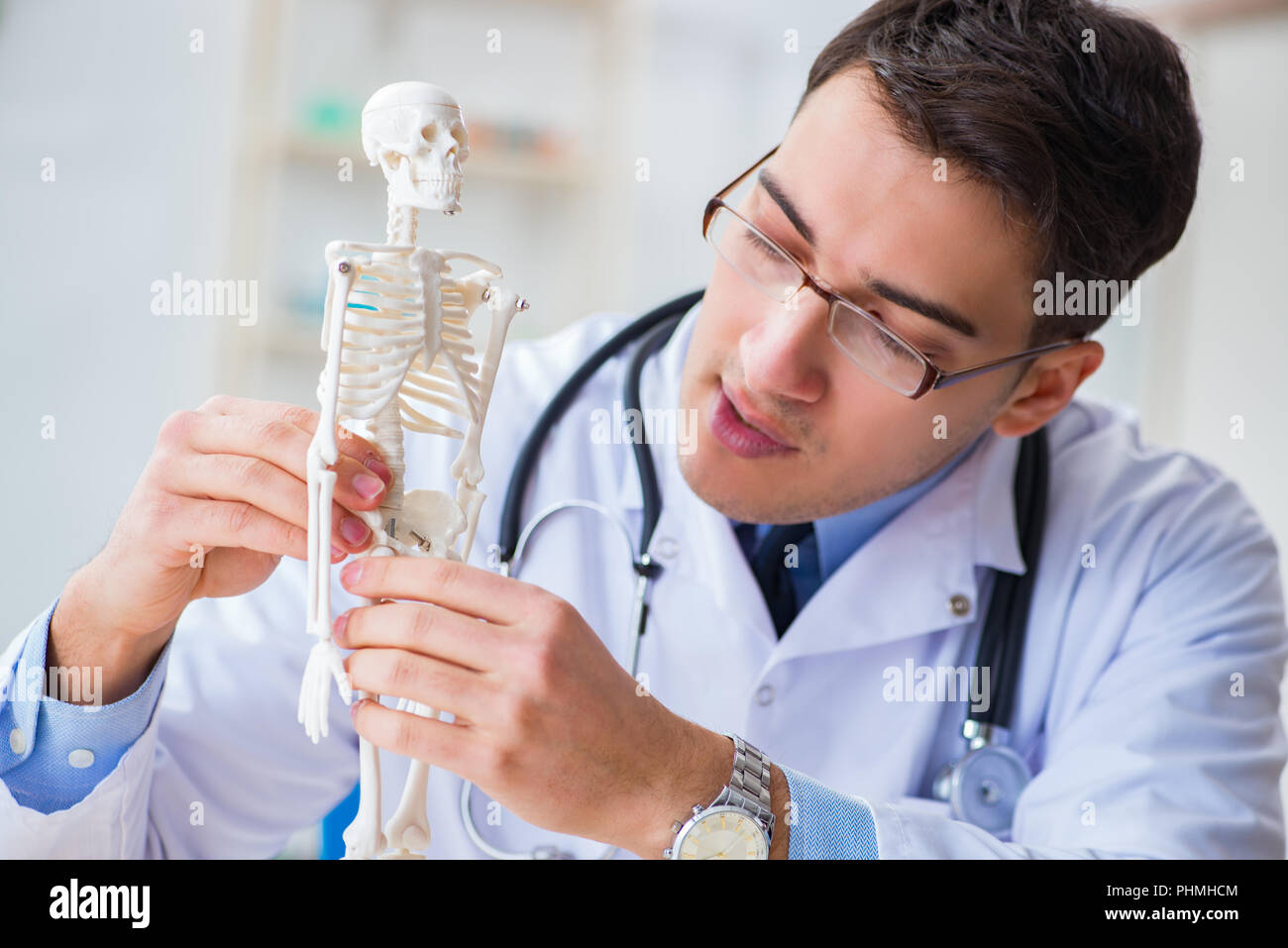 Doctor student studying the bones of skeleton Stock Photo - Alamy