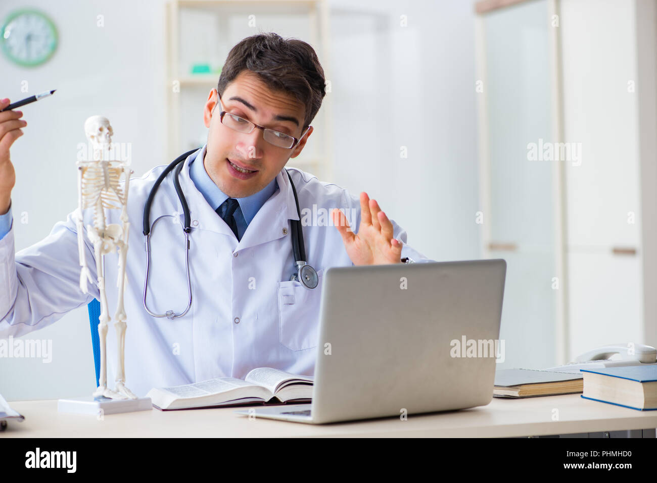Doctor student studying the bones of skeleton Stock Photo - Alamy