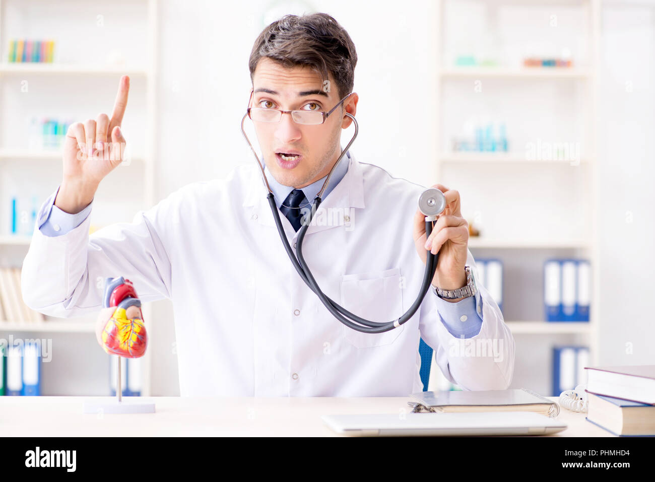 Doctor lecturer explaining the heart model Stock Photo - Alamy