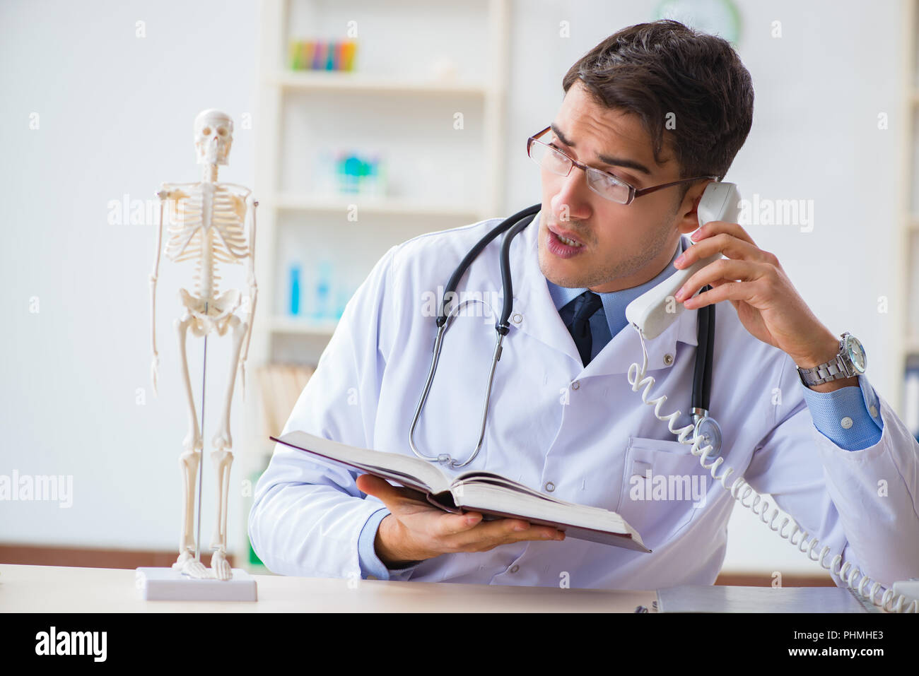 Doctor student studying the bones of skeleton Stock Photo - Alamy