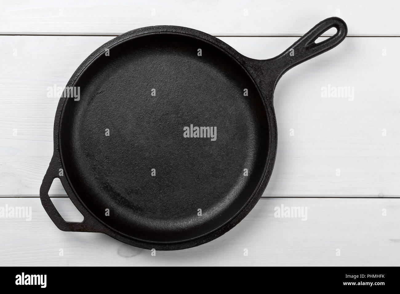 Empty, clean black cast iron pan or dutch oven top view from above on ...