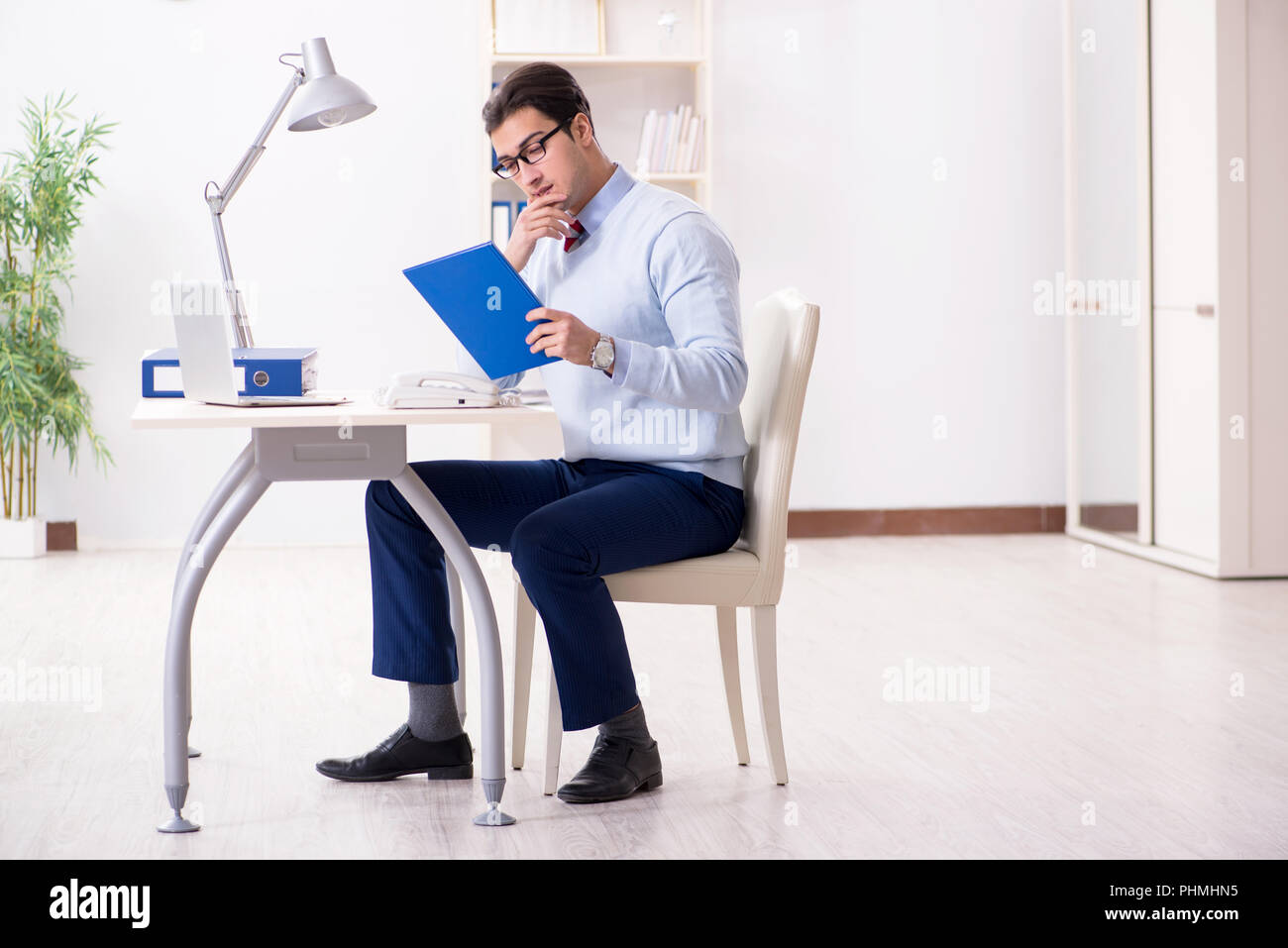 Young handsome businessman employee working in office at desk Stock ...