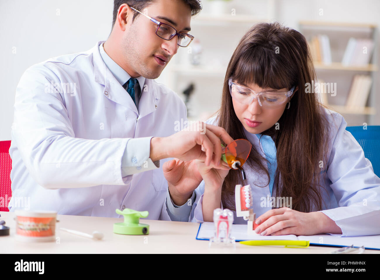 Doctor explaining to assistant how to use ultraviolet gun Stock Photo ...