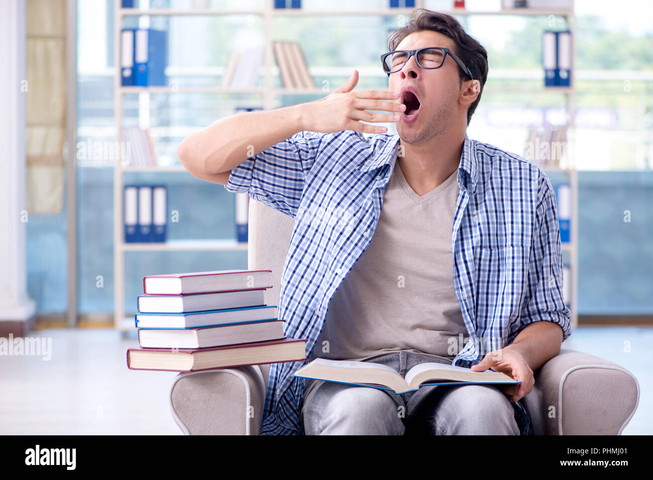 Student reading books and preparing for exams in library Stock Photo ...