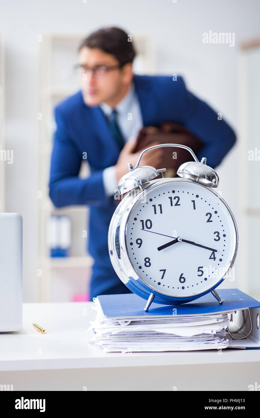 Businessman in bad time management concept Stock Photo - Alamy