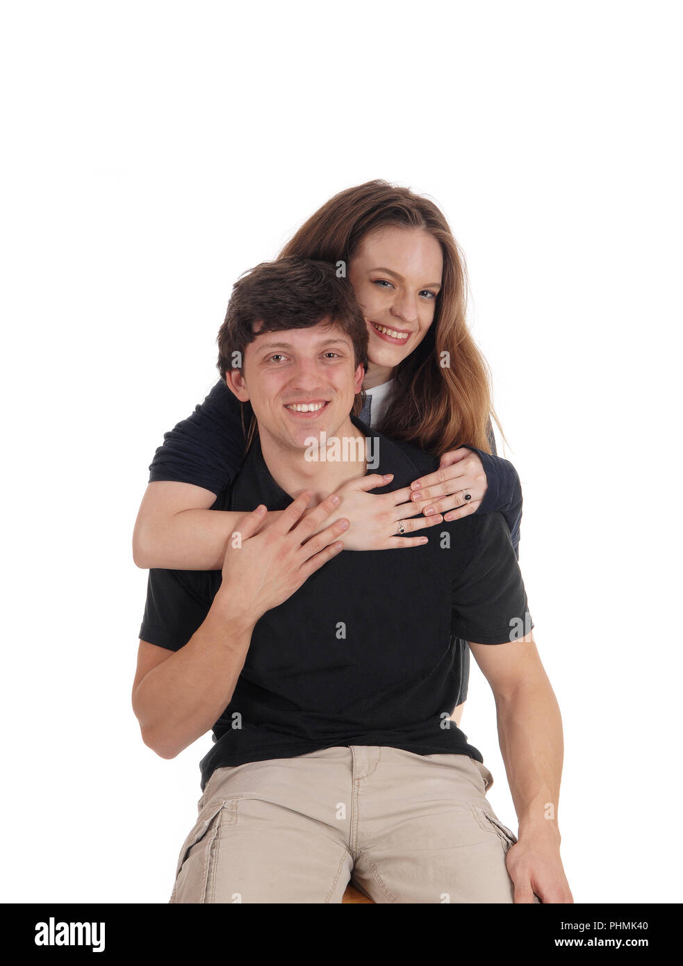Young couple, she is hugging him from behind Stock Photo - Alamy