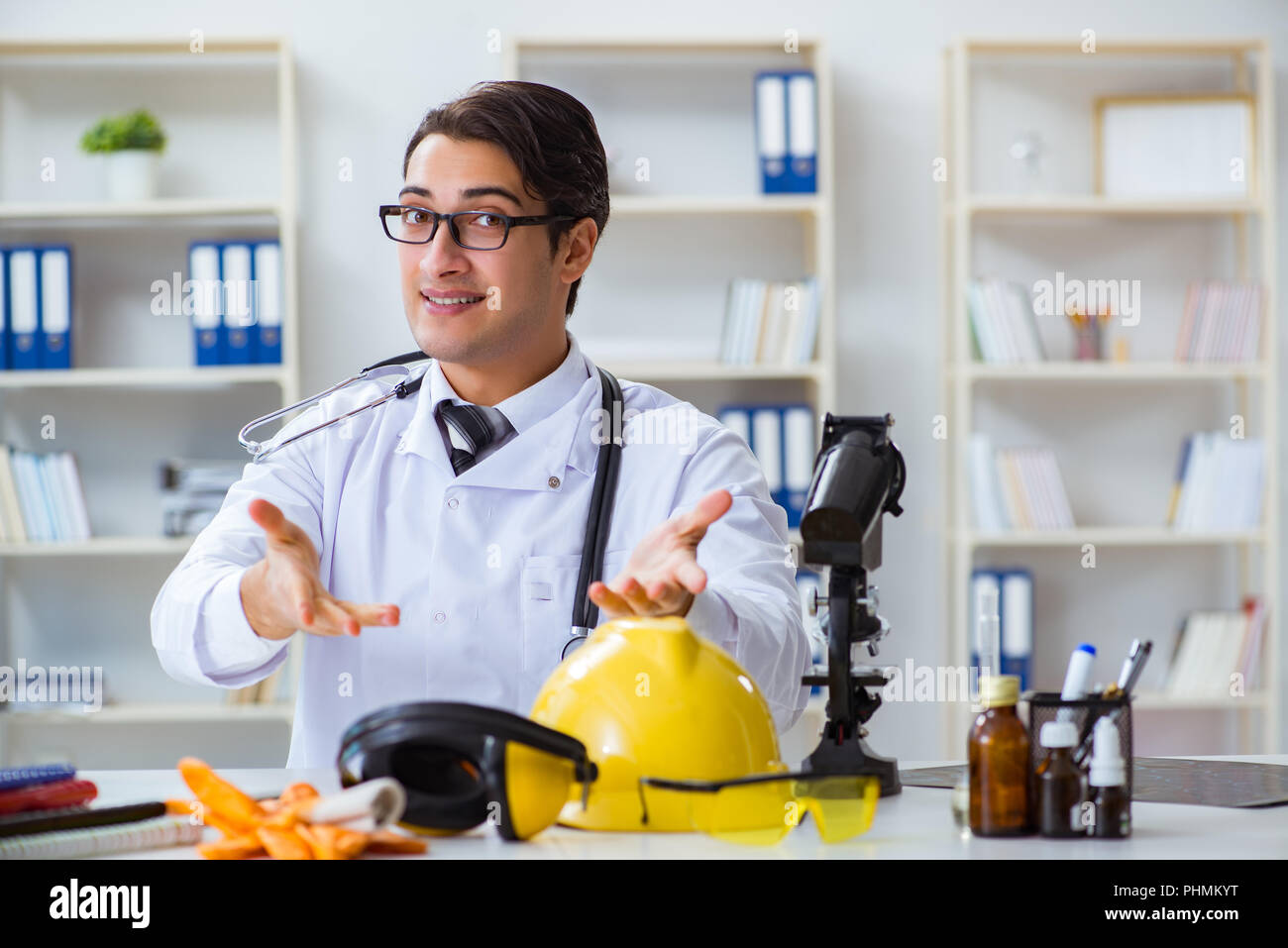 Safety doctor advising about wearing hard hat Stock Photo - Alamy