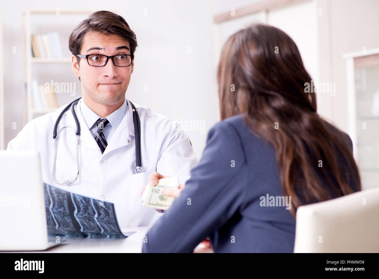 Doctor in corruption concept with being offered bribe Stock Photo - Alamy