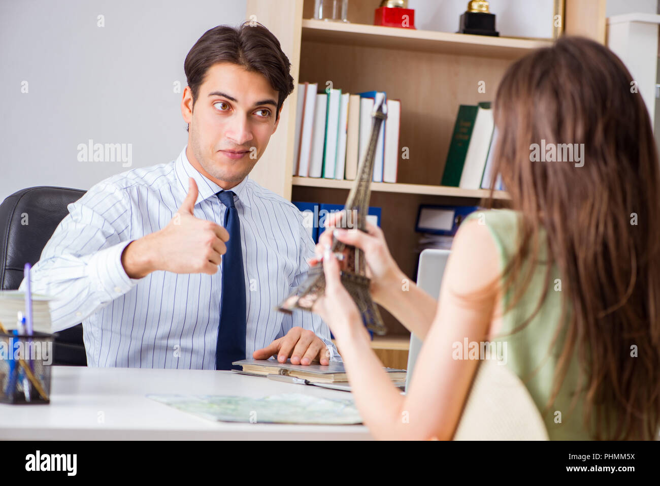 Customer visiting travel agency and talking to agent Stock Photo - Alamy
