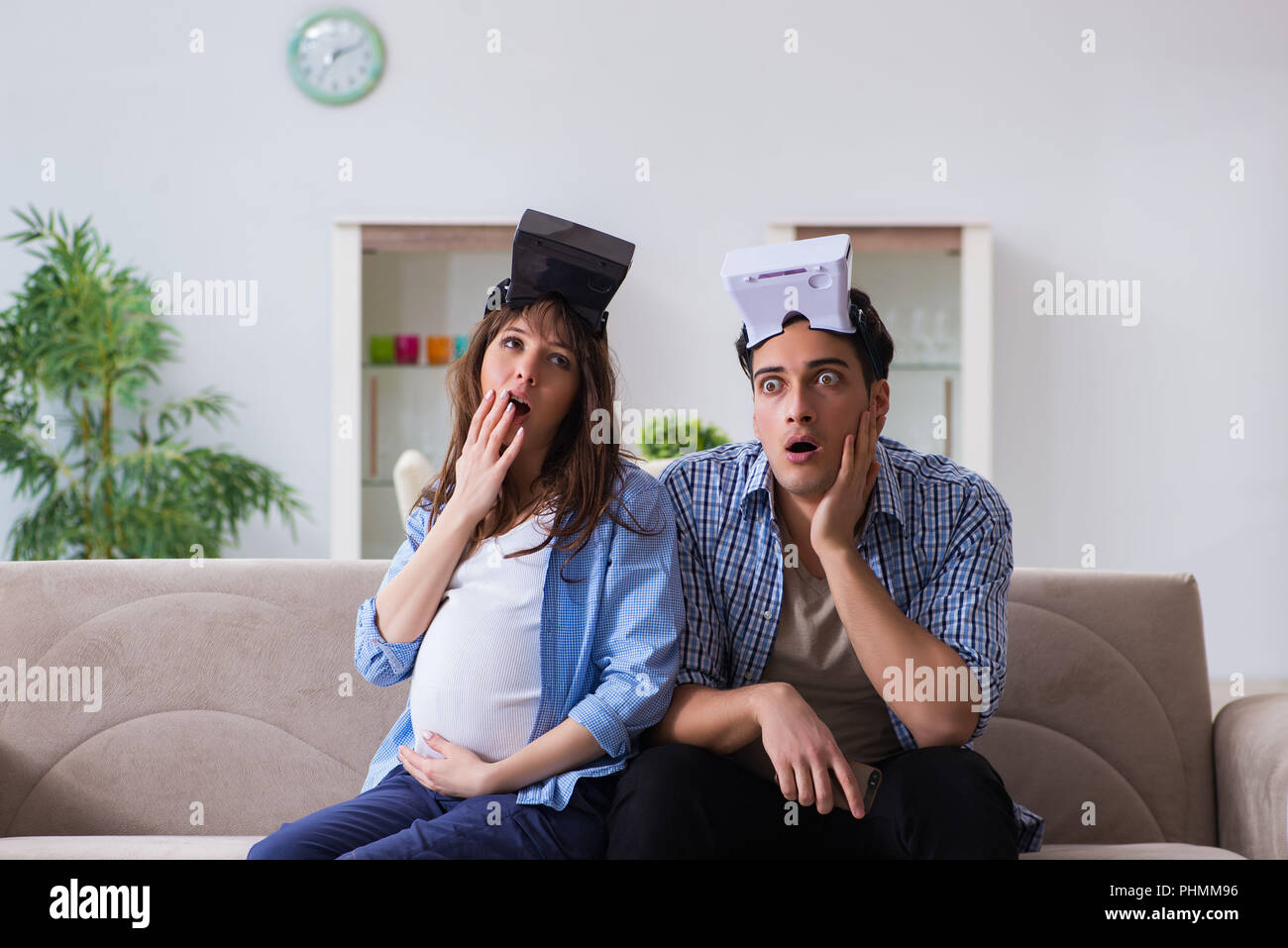 Young couple trying virtual reality glasses goggles Stock Photo - Alamy