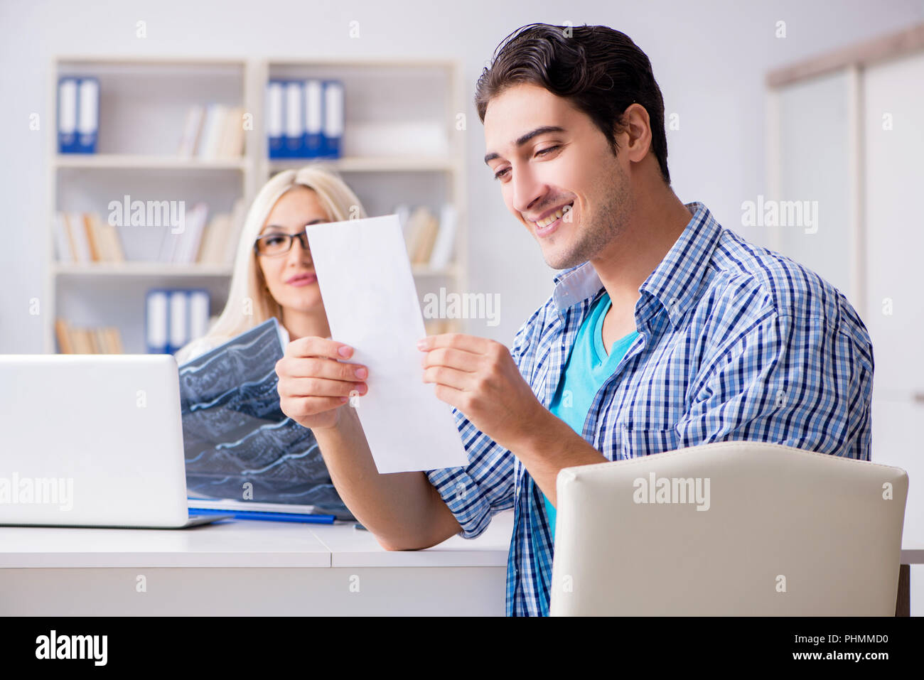 Male patient angry at expensive healthcare bill Stock Photo - Alamy