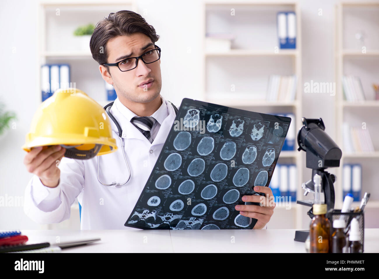 Safety doctor advising about wearing hard hat Stock Photo - Alamy