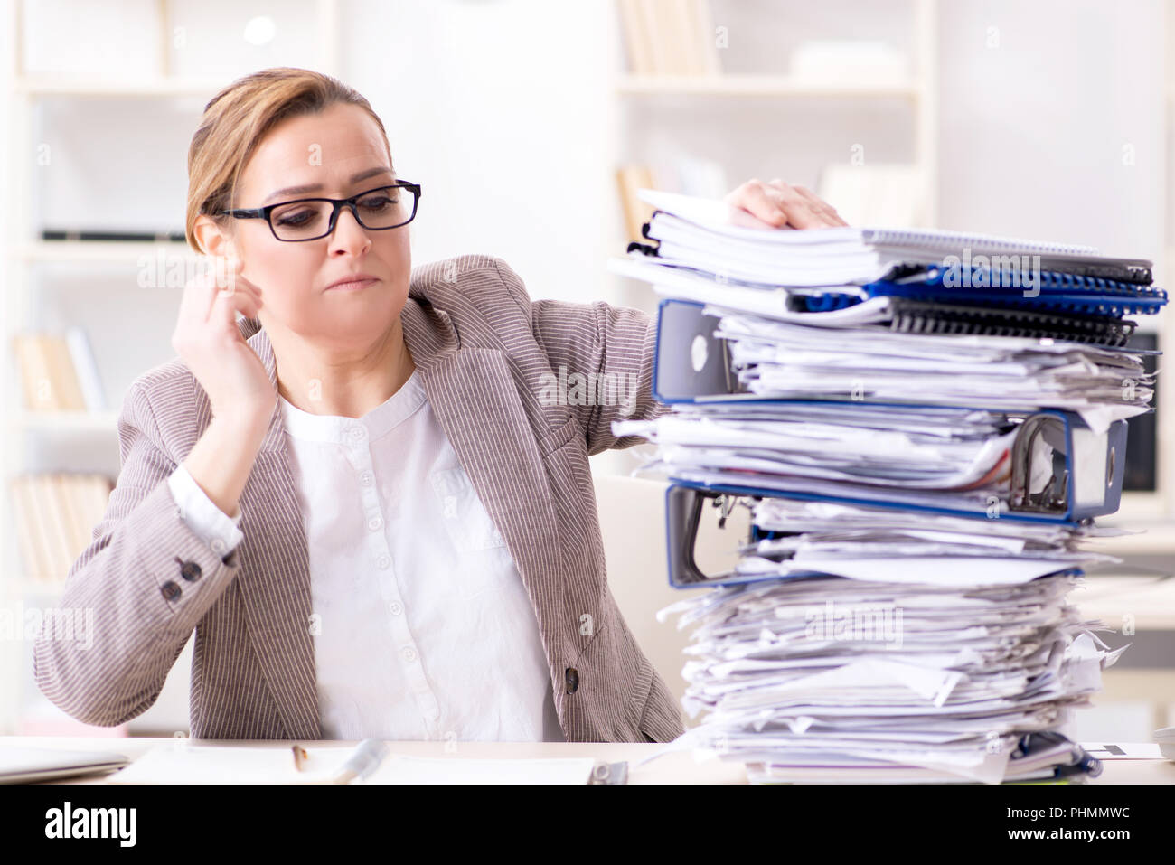 Businesswoman very busy with ongoing paperwork Stock Photo - Alamy