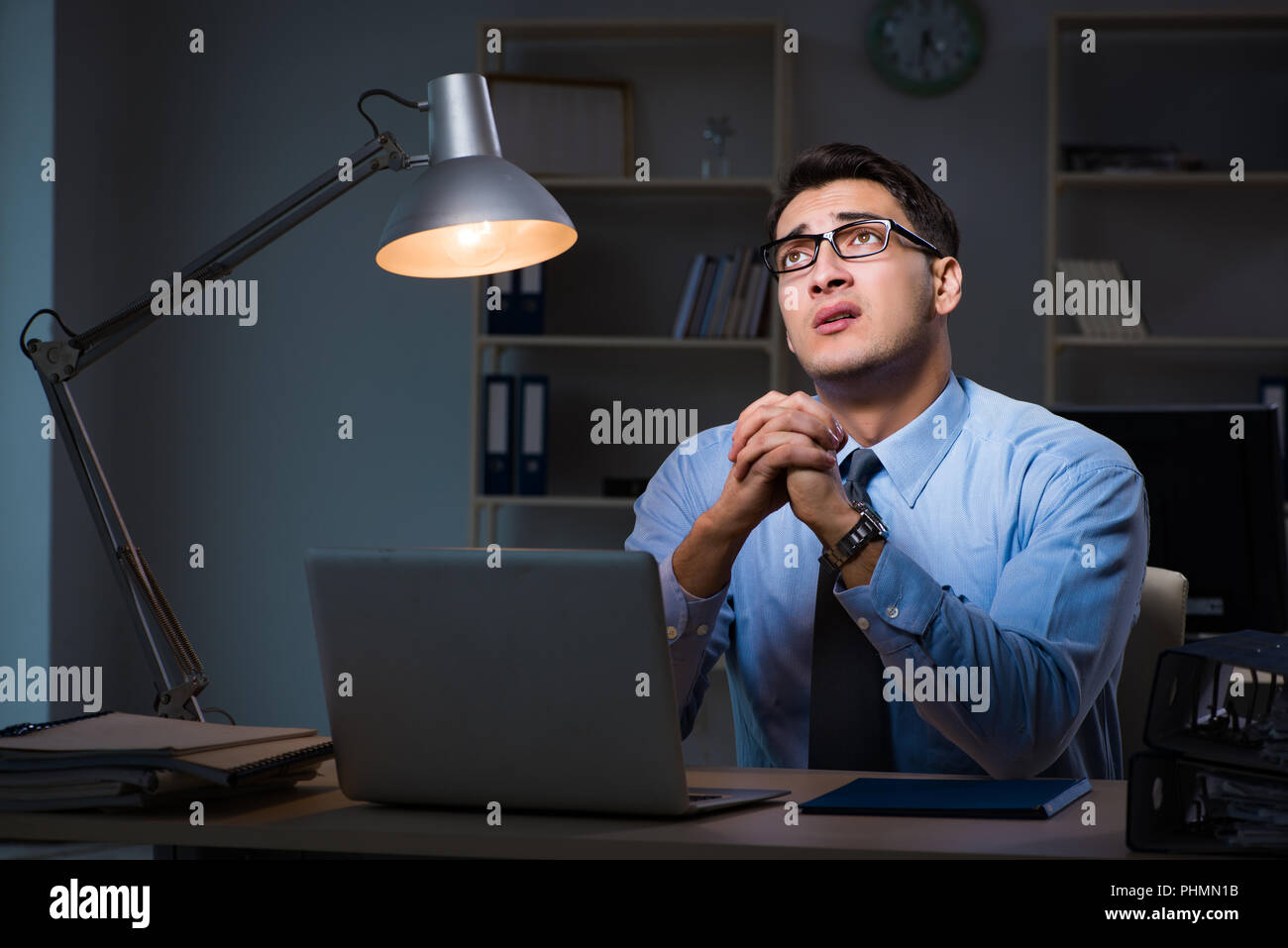Employee working late at night at important report Stock Photo - Alamy