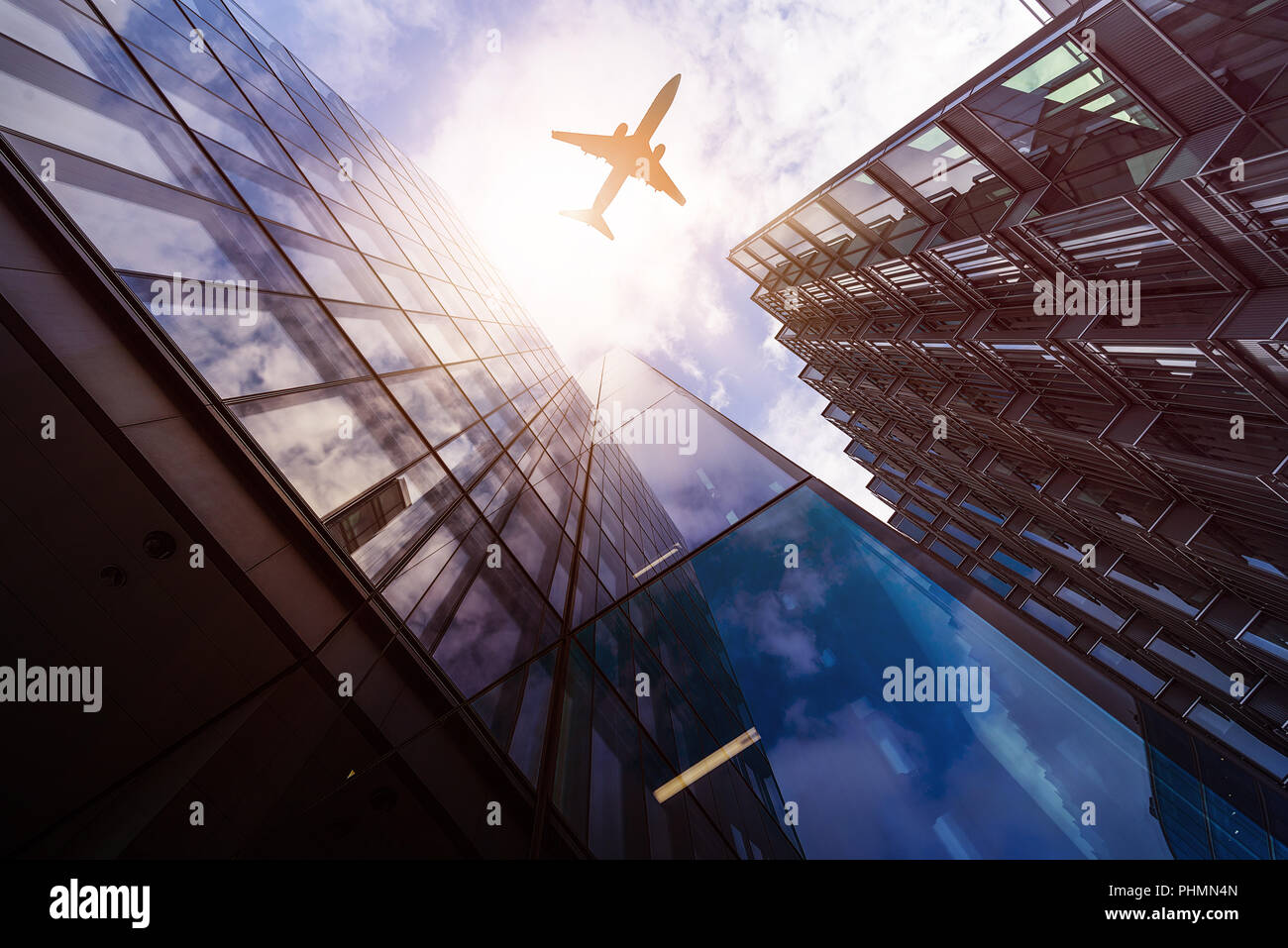 plane over highrise buildings Stock Photo - Alamy