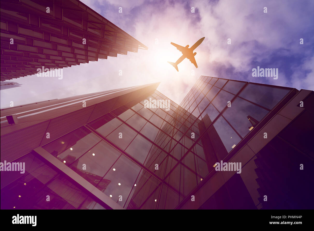 plane over highrise buildings Stock Photo - Alamy