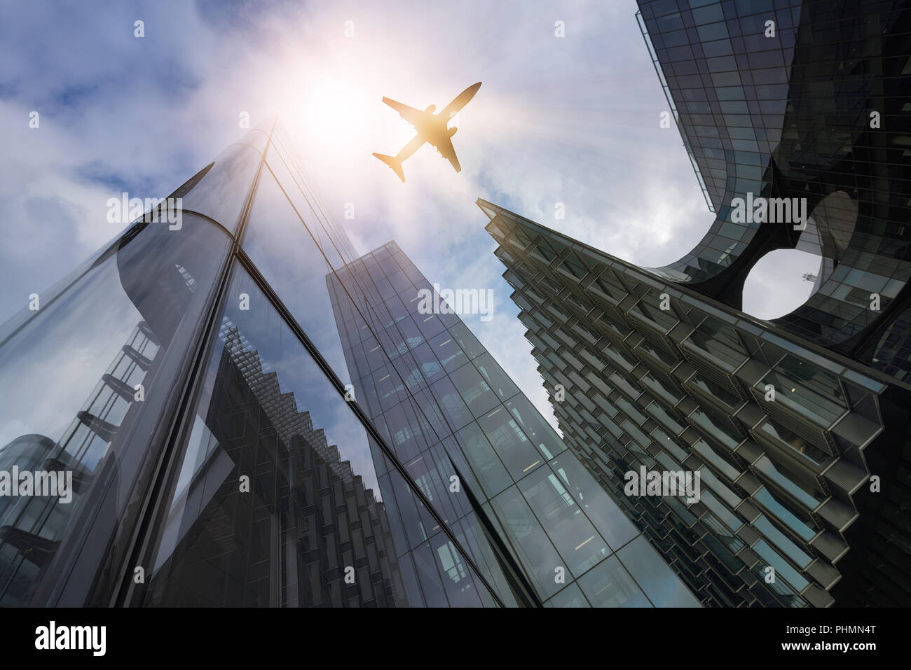 plane over highrise buildings Stock Photo - Alamy