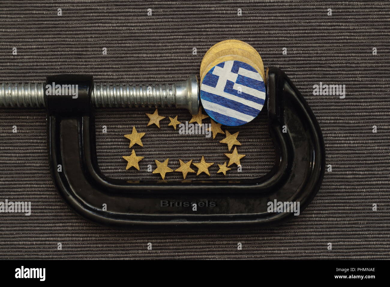 Greece coin is clamp pressure Stock Photo - Alamy