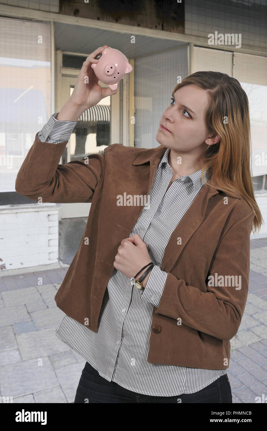 Woman holding piggy bank Stock Photo - Alamy