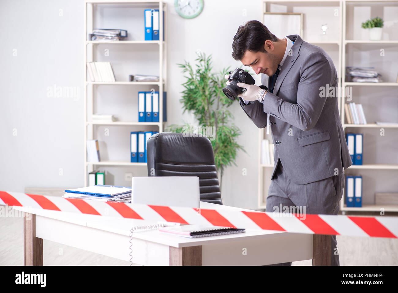 Forensics investigator at the scene of office crime Stock Photo - Alamy