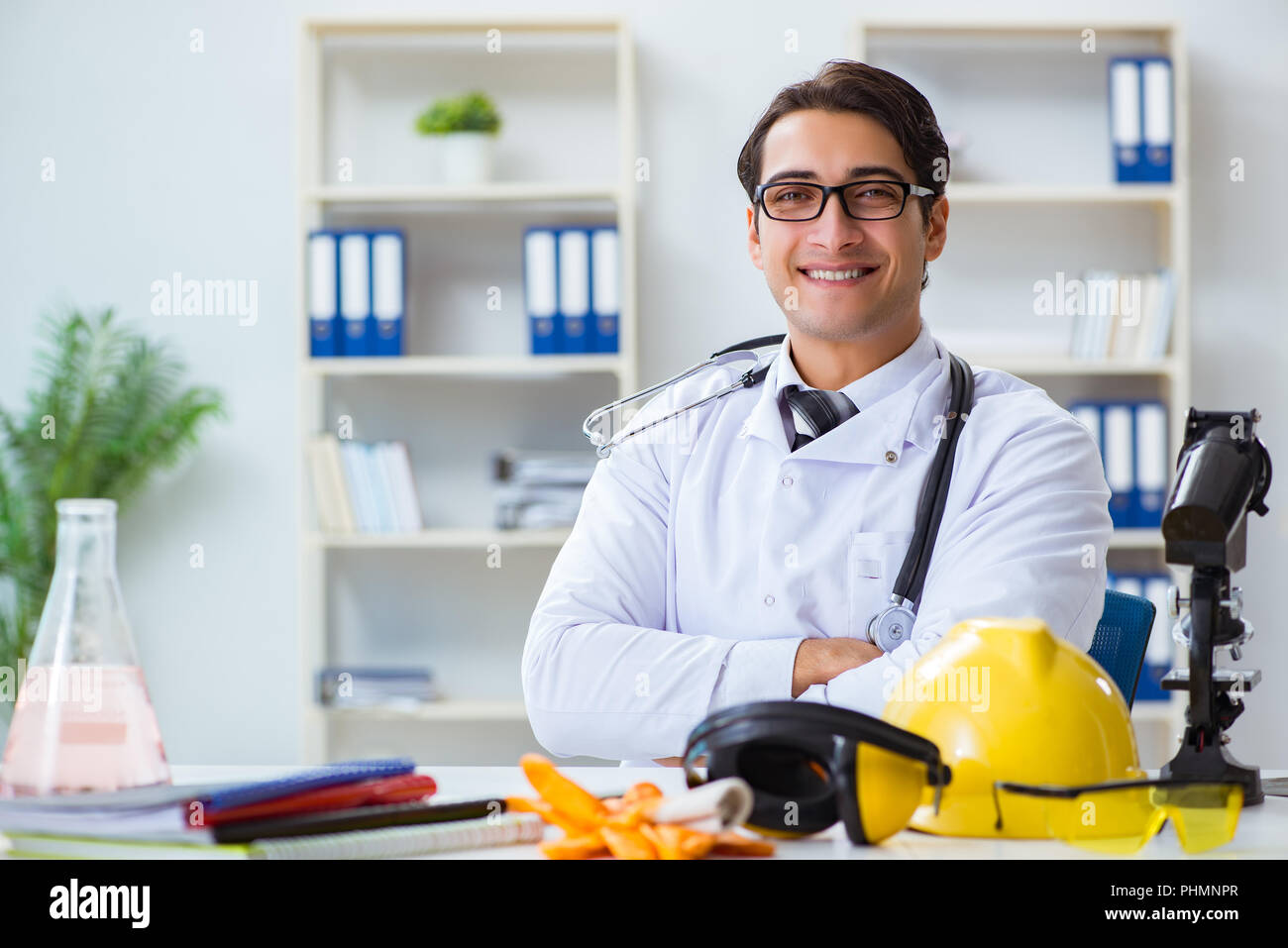 Safety doctor advising about wearing hard hat Stock Photo - Alamy