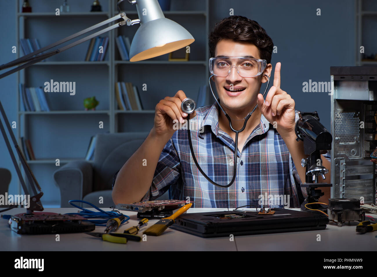 Computer repair concept with man inspecting with stethoscope Stock ...