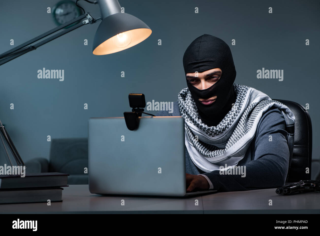 Hacker wearing balaclava mask hacking computer Stock Photo - Alamy
