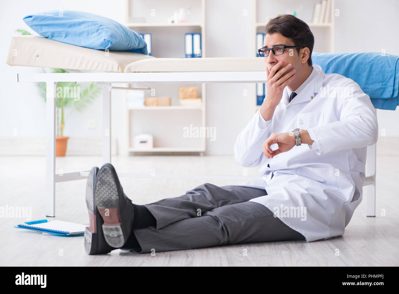 Doctor sitting on the floor in hospital Stock Photo - Alamy