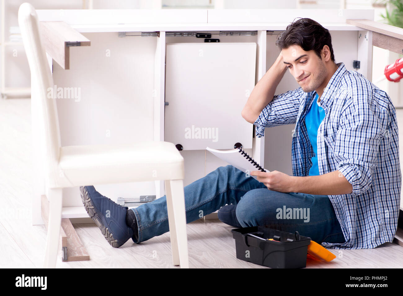 Husband repairing broken table at home Stock Photo - Alamy