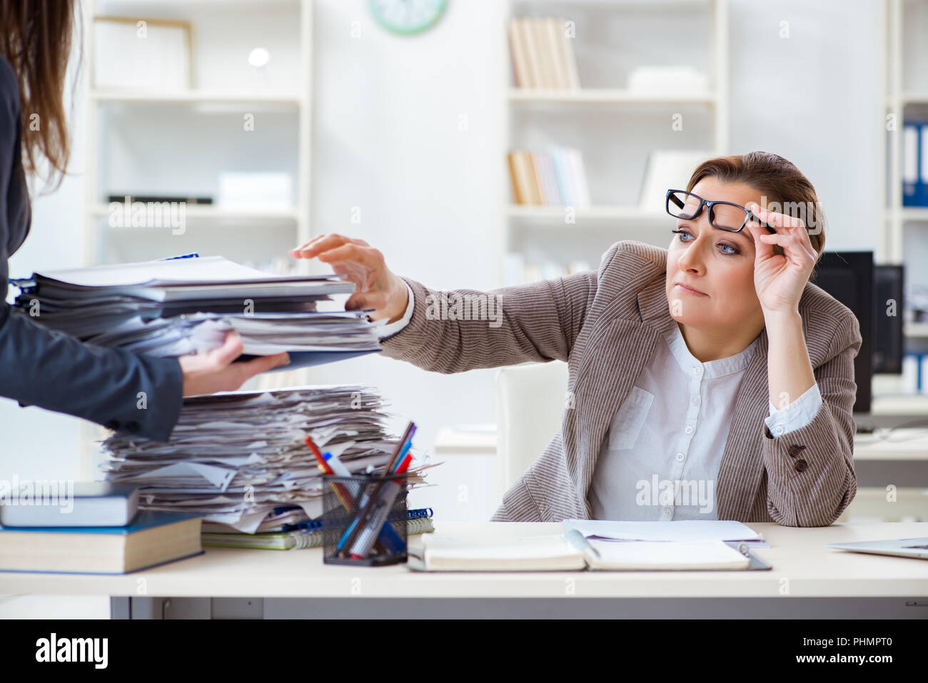 Businesswoman very busy with ongoing paperwork Stock Photo - Alamy