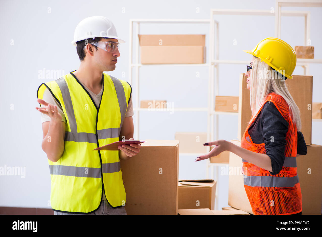 Delivery contractor delivering boxes to office Stock Photo - Alamy
