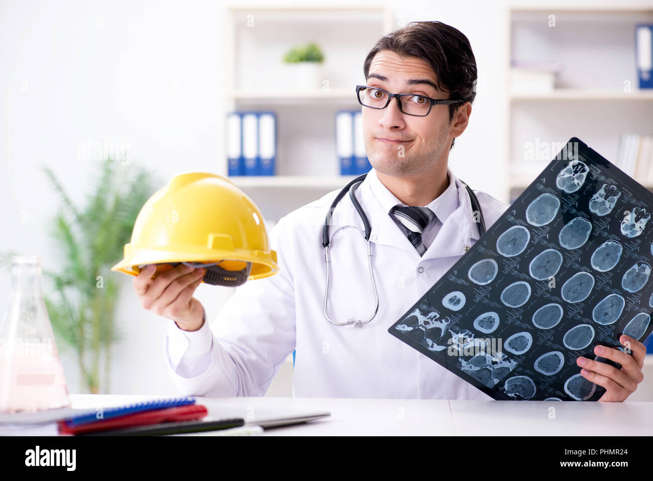 Safety doctor advising about wearing hard hat Stock Photo - Alamy