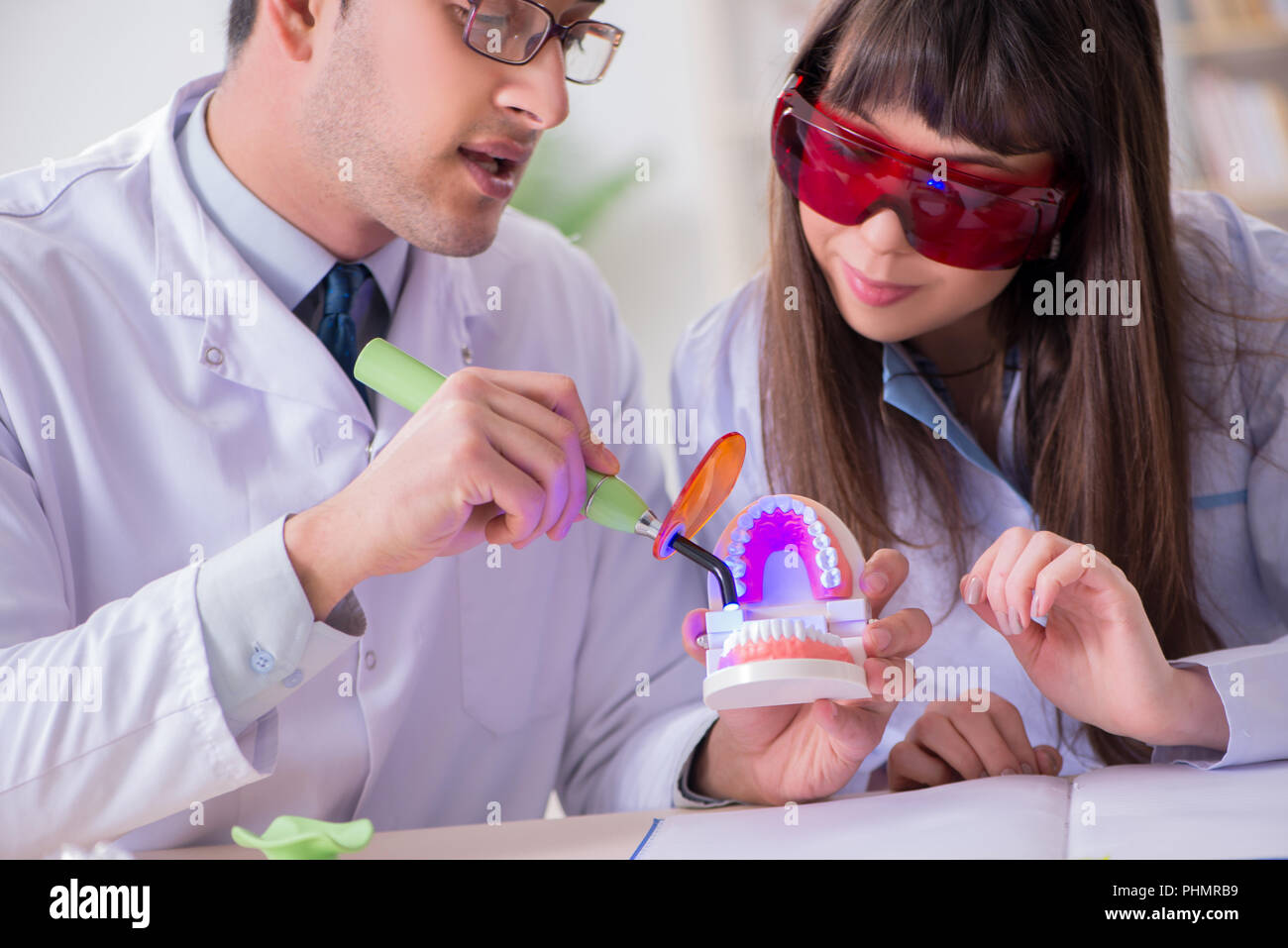 Doctor explaining to assistant how to use ultraviolet gun Stock Photo ...