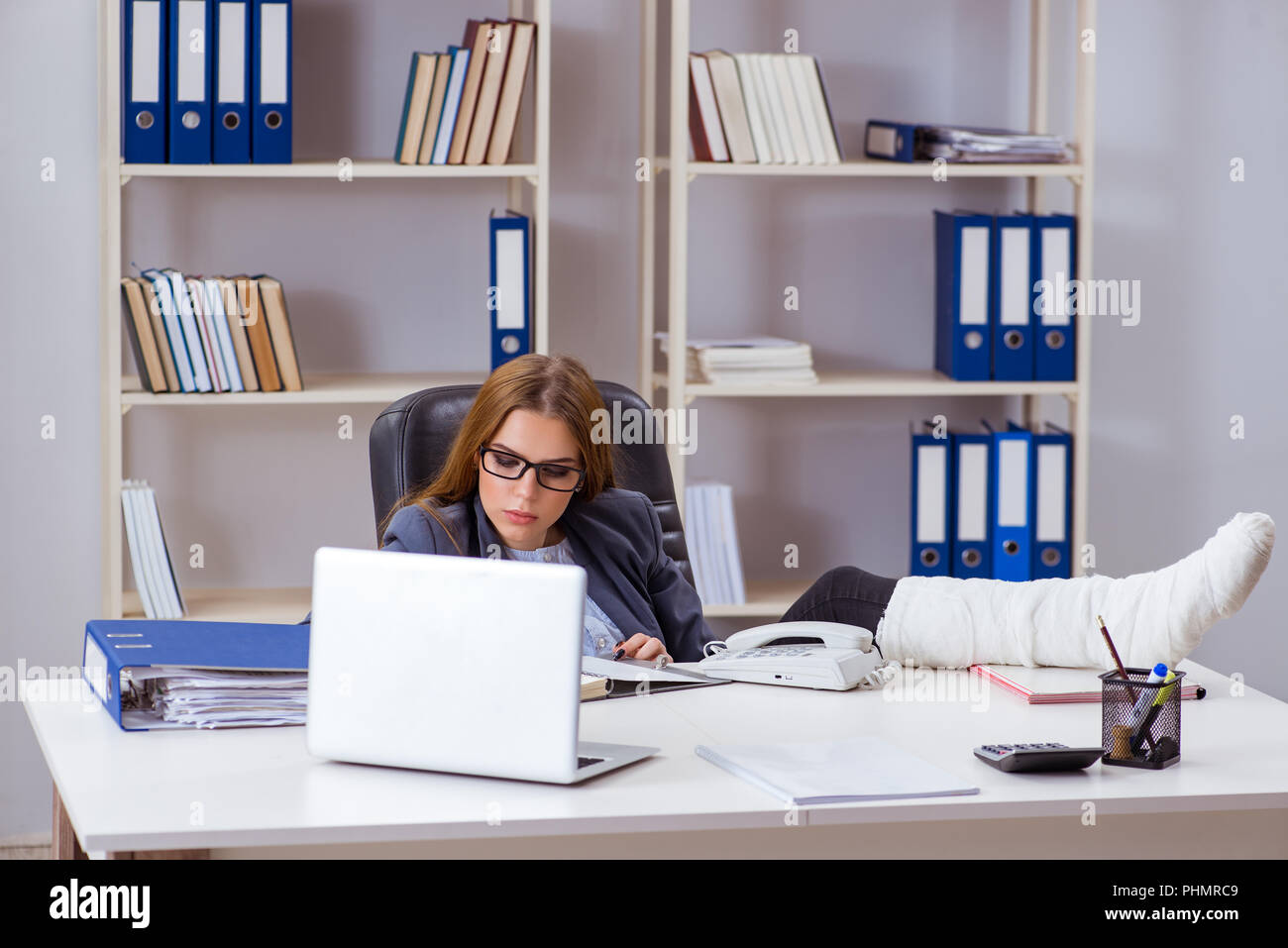 Busiesswoman employee with broken leg in office Stock Photo - Alamy