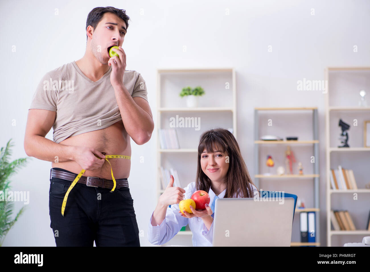 Doctor dietician giving advices to fat overweight patient Stock Photo ...