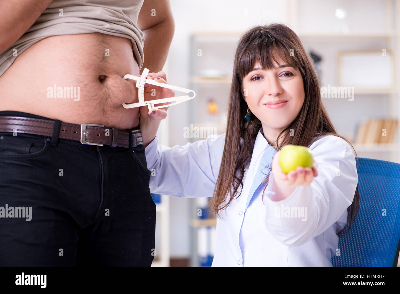 Doctor dietician giving advices to fat overweight patient Stock Photo ...