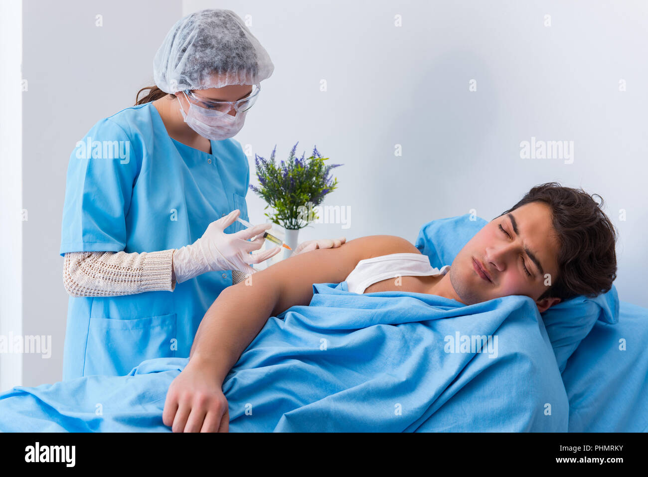 Doctor doing medical injection in hospital room Stock Photo - Alamy