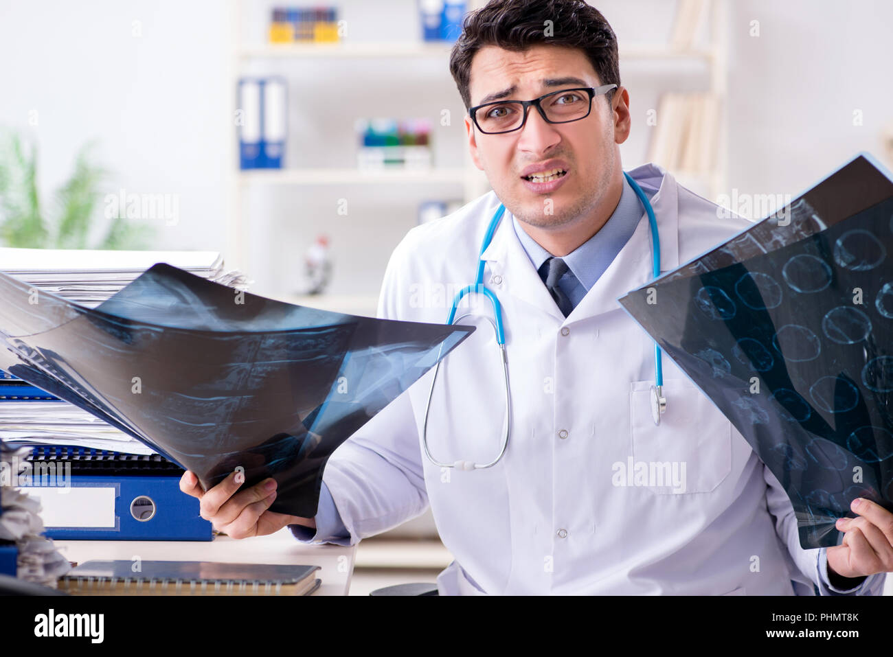 Tired radiologist with x-ray image in hospital Stock Photo - Alamy