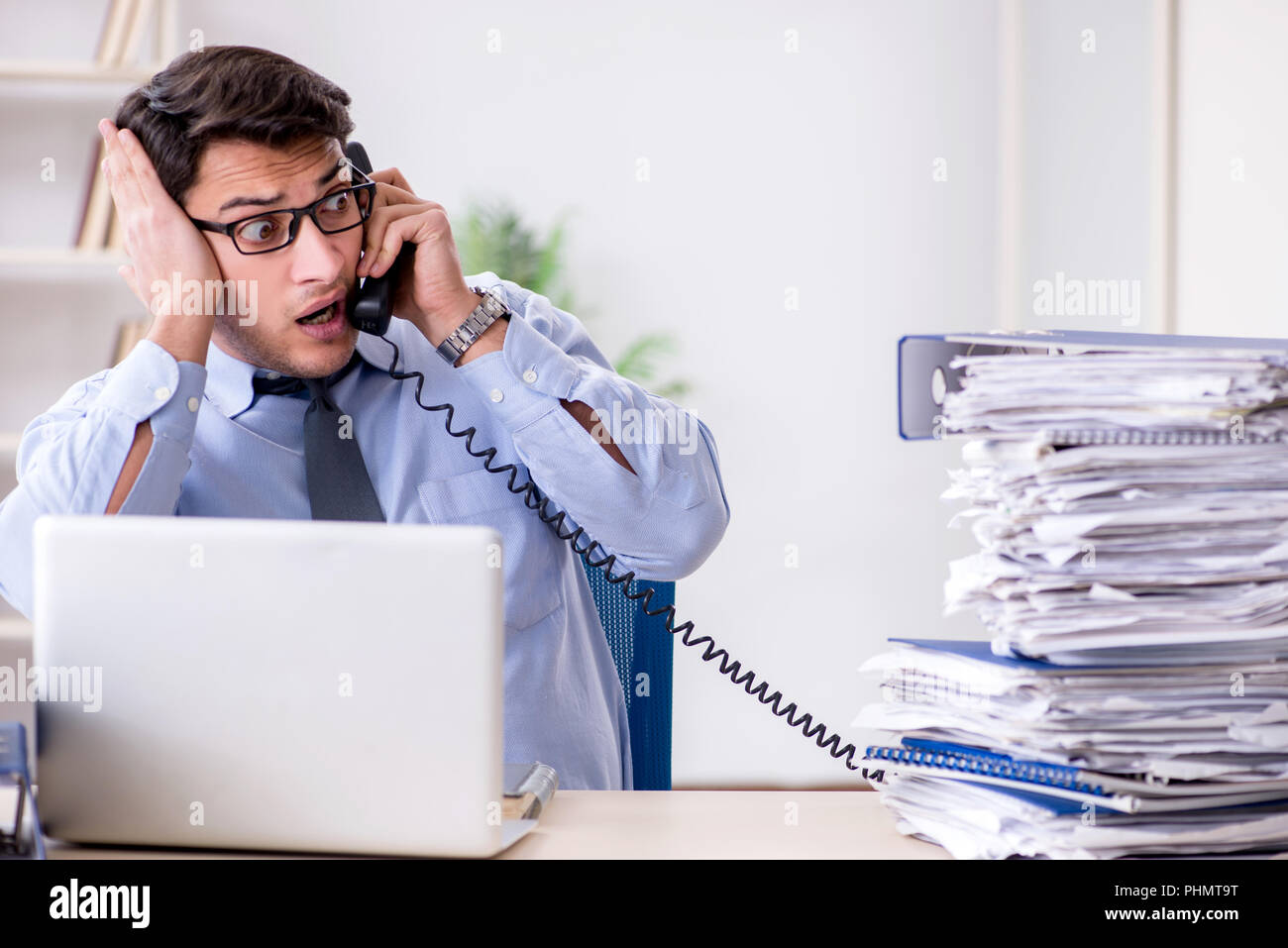 Extremely busy businessman working in office Stock Photo - Alamy