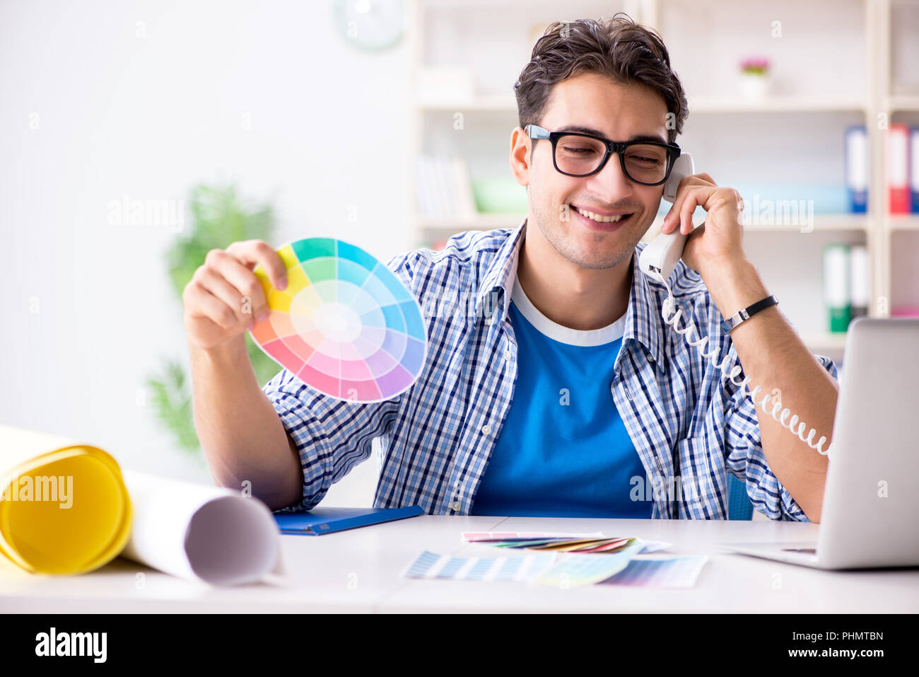 Young designer working on new project and choosing colours Stock Photo ...
